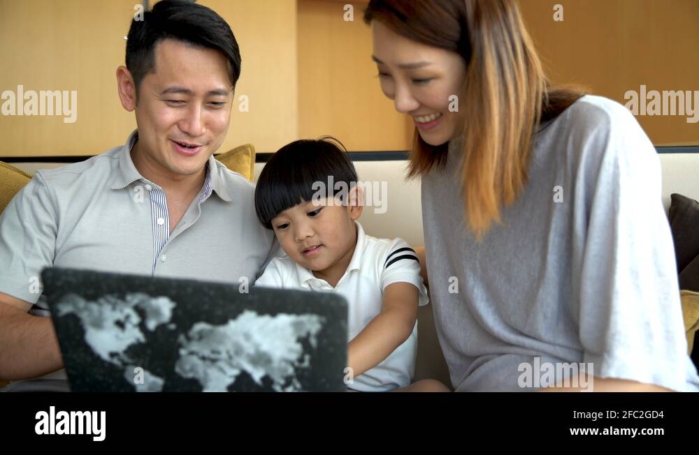 Chinese Asian parents helping son with school research Stock Video ...