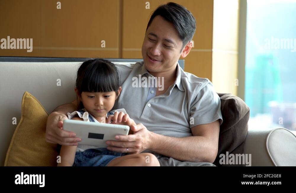 Chinese Asian dad enjoying time with daughter learning Stock Video ...
