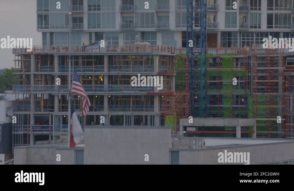 American flag and Texas flag flying in front of construction site in ...