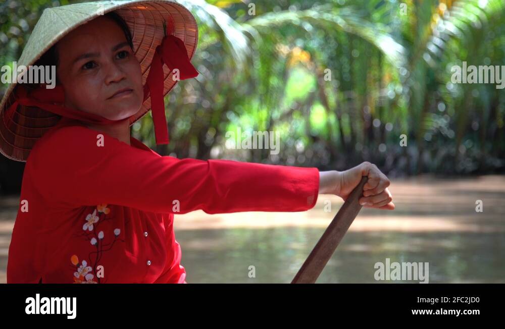 Female wearing conical hat paddling Sampan South Vietnam Stock Video ...