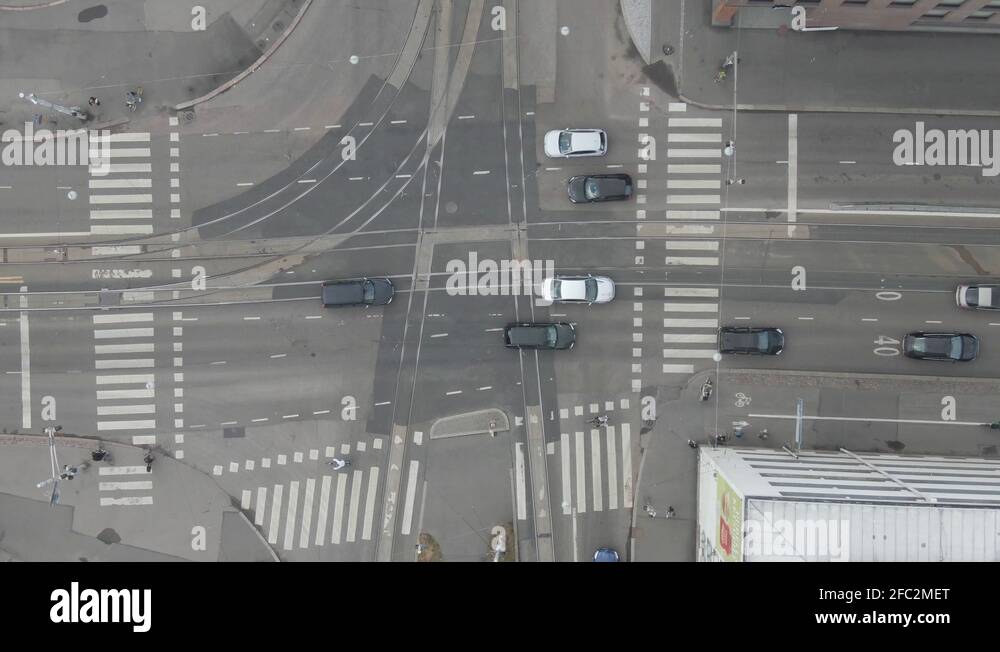 Cars, trams and people on crossroad. Crossing street with traffic ...