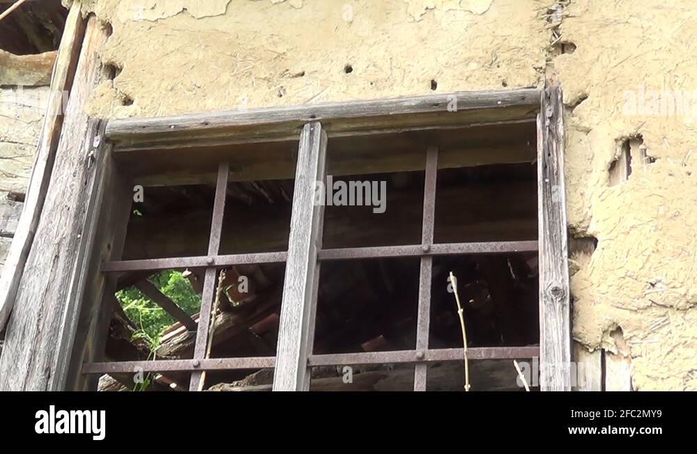 The old broken window with bars on the old cottage Stock Video Footage ...