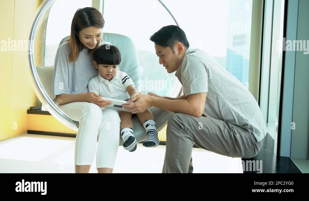 Chinese Asian parents helping son with educational activity Stock Video ...