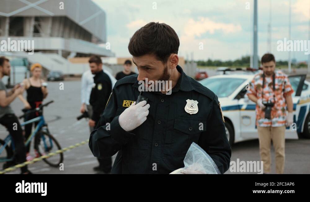 close-up portrait of african american police officer talking by walkie ...