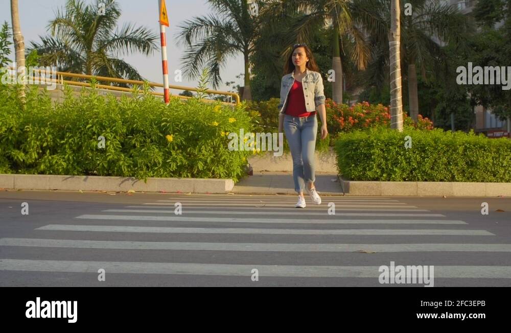 Woman crossing road Stock Videos & Footage - HD and 4K Video Clips - Alamy