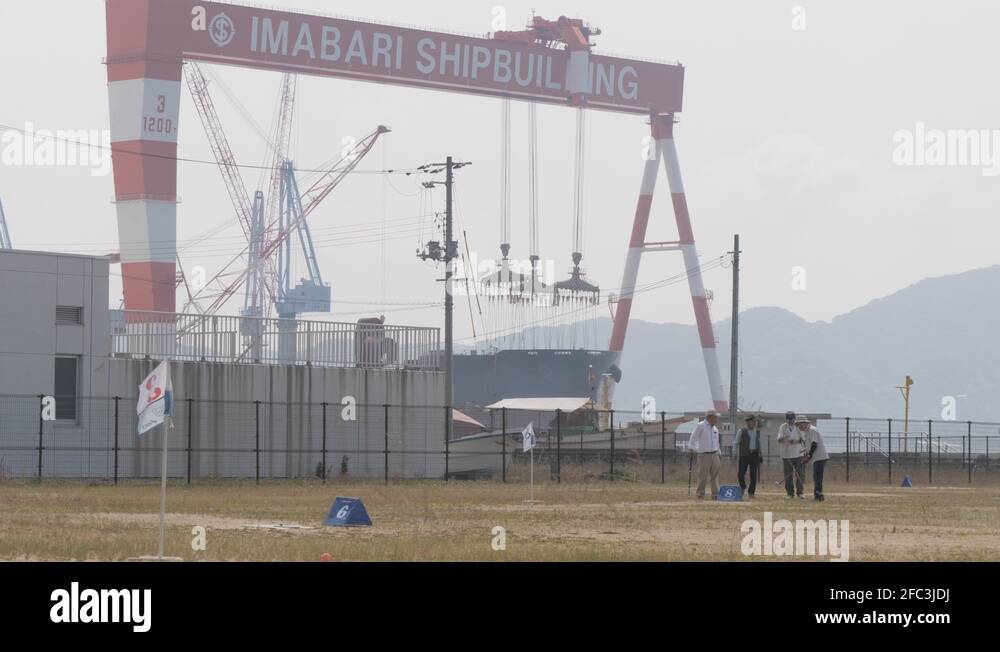People playing ground golf near shipyard,Mihara,Honshu,Japan Stock ...