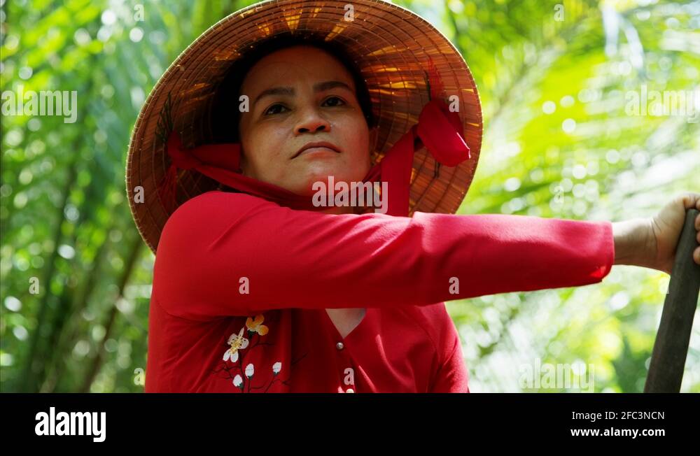 Vietnamese lady wearing conical hat on Sampan Vietnam Stock Video ...