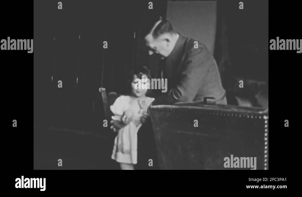 WW2 - Child stand beside Adolf Hitler eating Stock Video Footage - Alamy