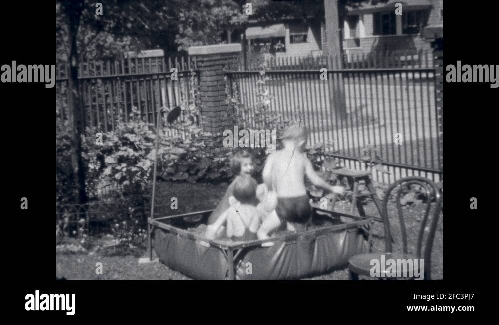 1930s: Kids playing in pool, jump into pool. Boys eating popcicles ...