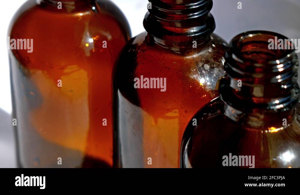Brown glass bottles. Cosmetics production. Refraction. Medical package ...