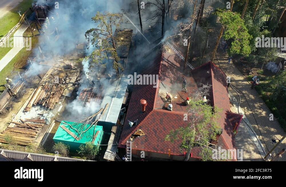 Firefighter on duty in Burning Building. Group firefighters fighting ...