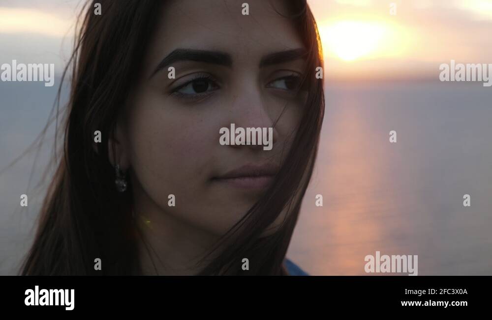 Dainty Brunette Girl Standing At Black Sea Beach At Sunset In Summer In Slo Mo Stock Video