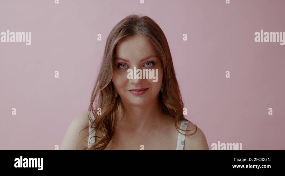 Camera Tilts Down From Face Of Caucasian Woman To Her Pregnant Belly
