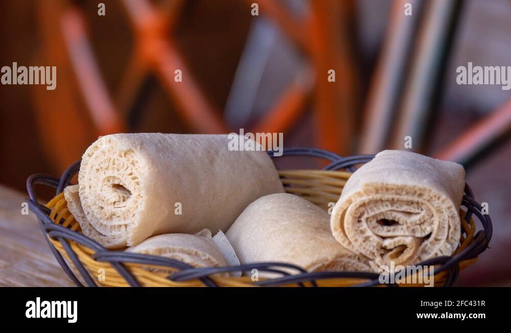 Zoom out on still image of rolls of Injera in a serving bowl Stock ...