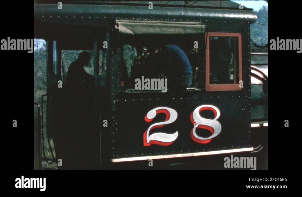 1940s: Men inside train compartment. Steam train engine. Plaque on ...