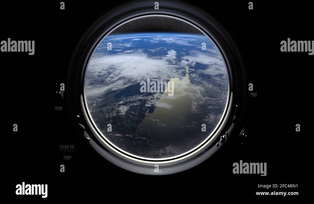 Earth through the porthole window of spaceship. International space ...