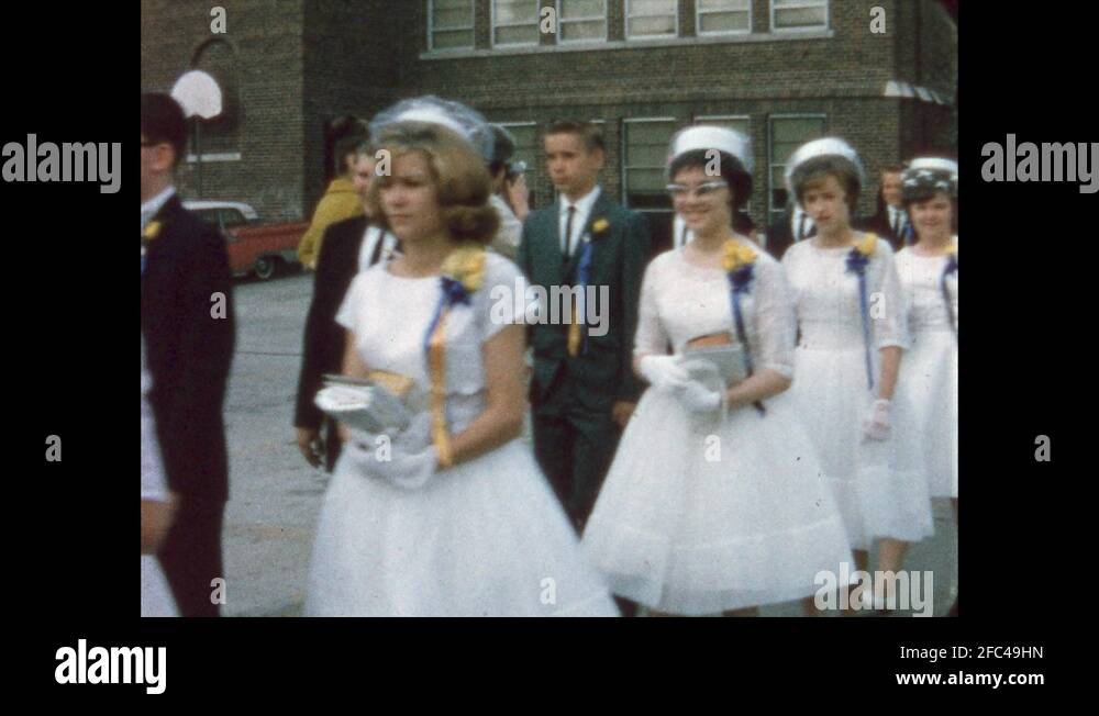 1940s: UNITED STATES: ladies in dresses and men in suits. Ceremony in ...