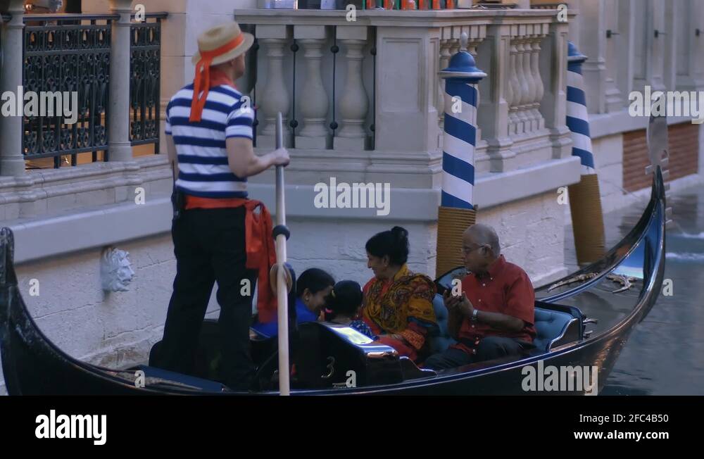 Family taking a gondola ride in The Venetian canals, Las Vegas. Close ...