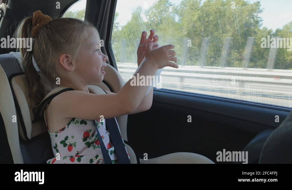 little girl rides in a car child seat, traveling by car with children ...