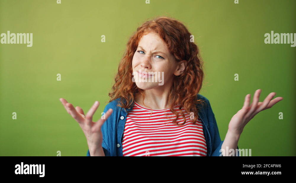 Portrait of pretty teenage girl raising hands with surprised face ...