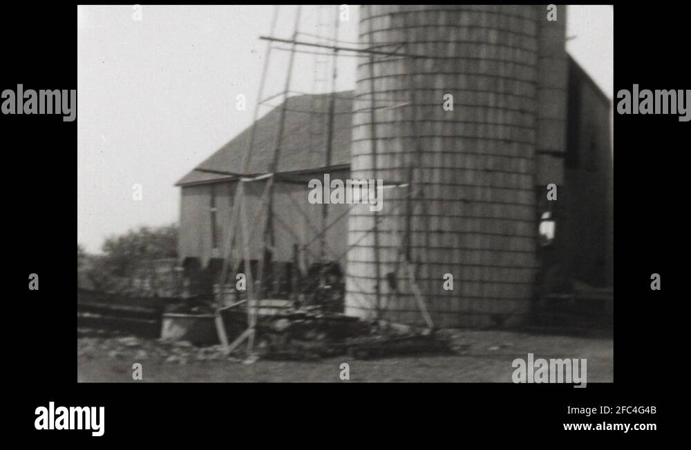 1920s: UNITED STATES: wind generator and chimney. Barn and farm ...