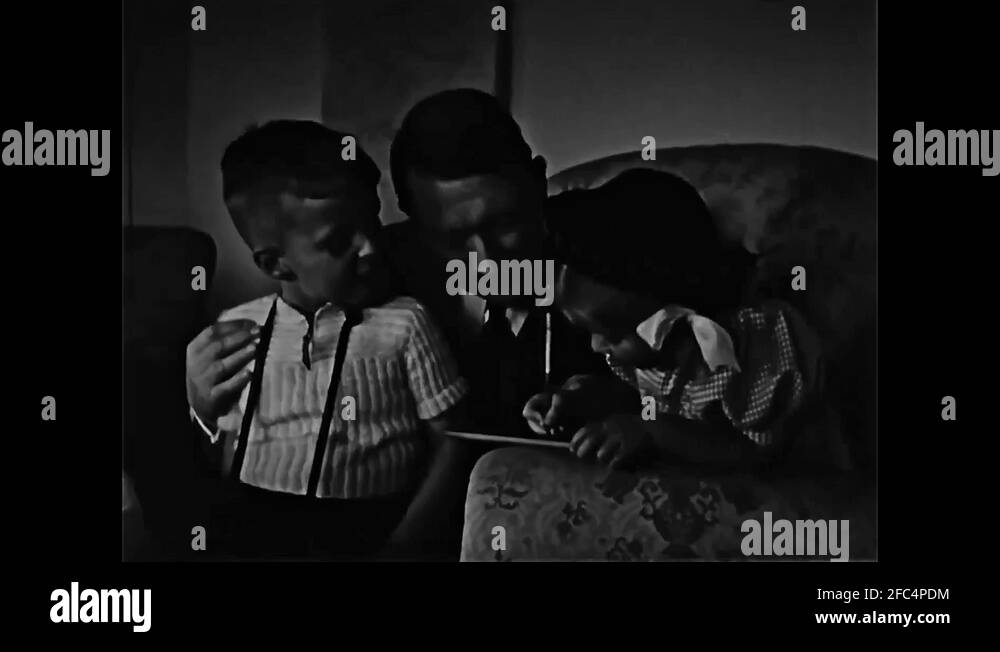 WW2 - Adolf Hitler sit with two childs on a sofa Stock Video Footage ...