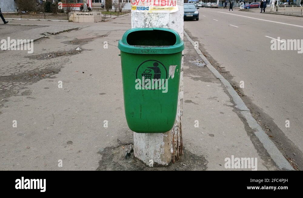 Trash bag in a concrete bin mounted on a pedestrian pavement Stock ...