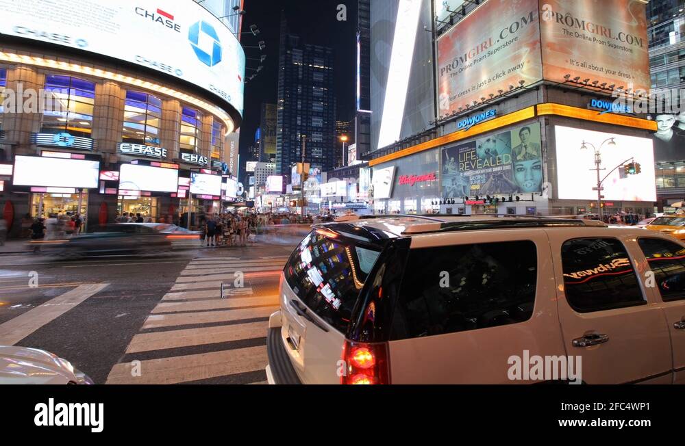Crowd of people walking in Times Square New York City at night time ...