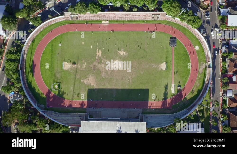 Zoom out Aerial Top View of Stadium in The Middle of Busy Town Stock ...