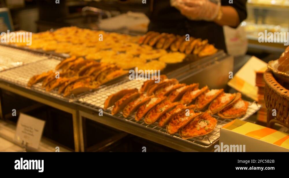 Women preparing pastries on display in a bakery Stock Video Footage - Alamy