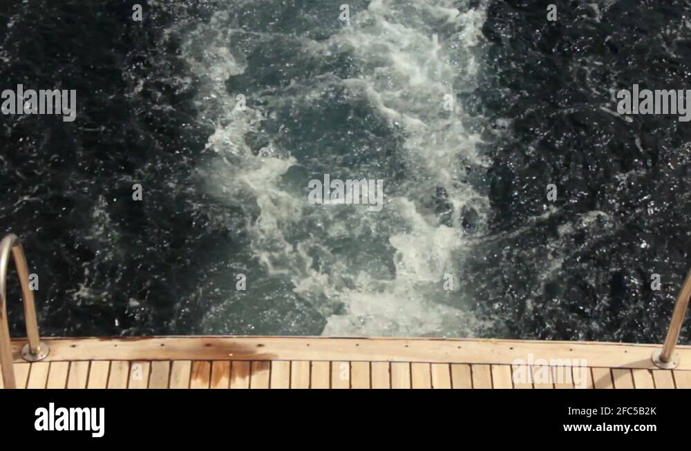 Water bubbling behind boat Stock Video Footage - Alamy
