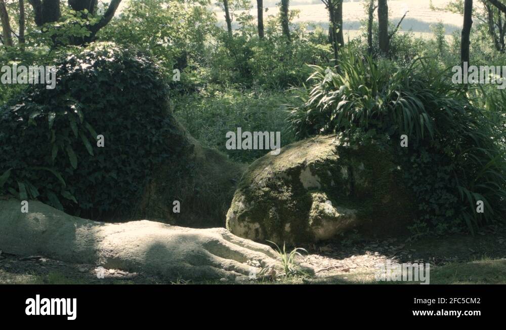 Ancient statue of a lady lying on the floor in The Lost Gardens of ...