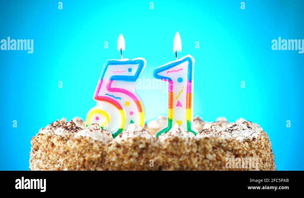 Birthday cake with a burning birthday candle. Number 51. Background ...