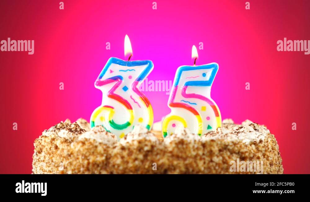 Birthday cake with a burning birthday candle. Number 35. Background ...