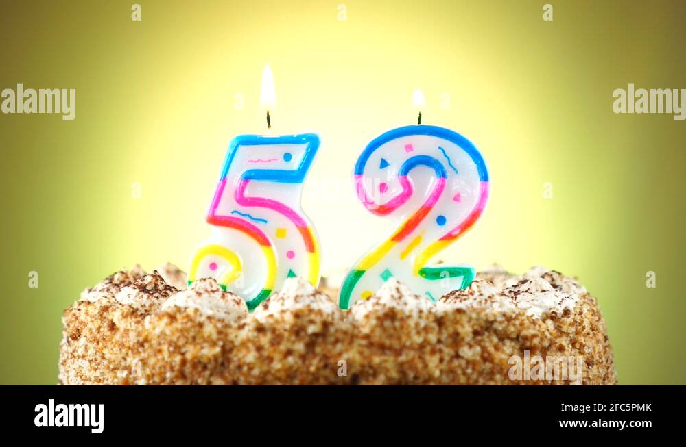 Birthday cake with a burning birthday candle. Number 52. Background ...