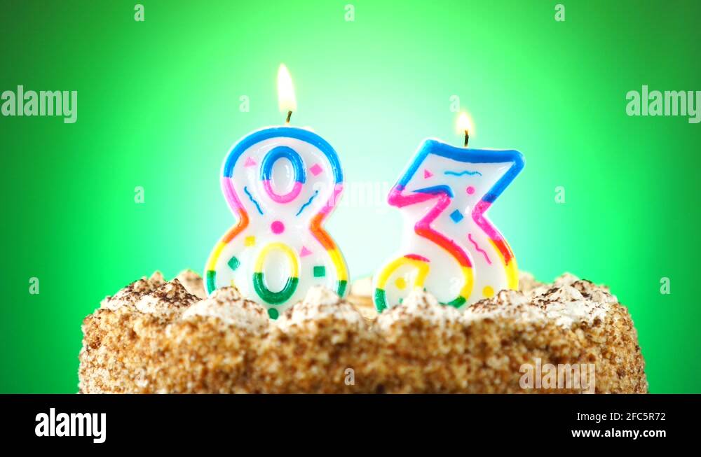 Birthday cake with a burning birthday candle. Number 83. Background ...