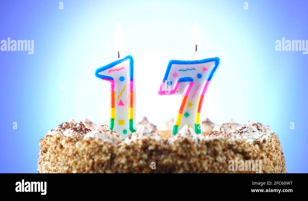 Birthday cake with a burning birthday candle. Number 17. Background ...