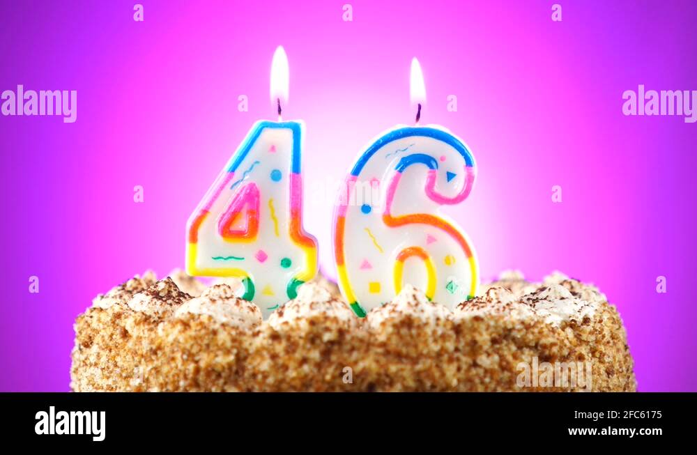 Birthday cake with a burning birthday candle. Number 46. Background ...