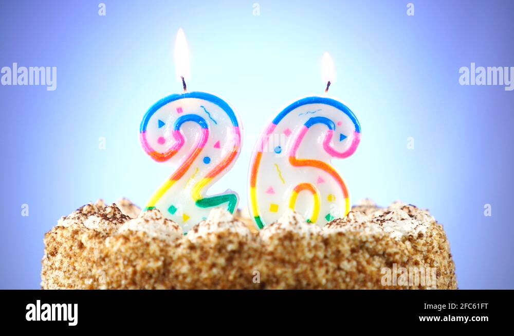 Birthday cake with a burning birthday candle. Number 26. Background ...