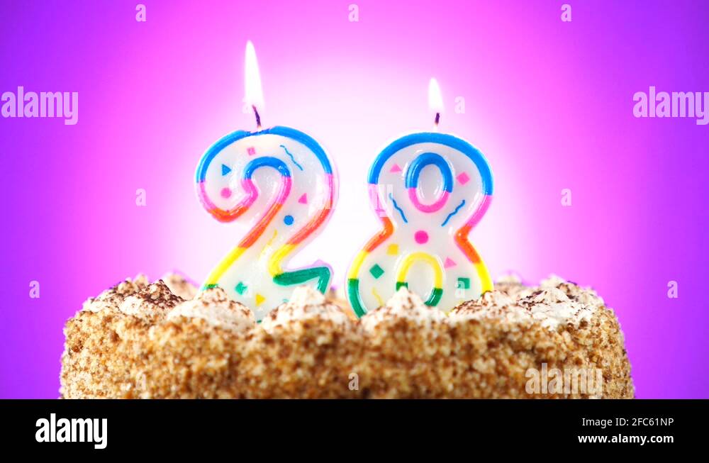 Birthday cake with a burning birthday candle. Number 28. Background ...