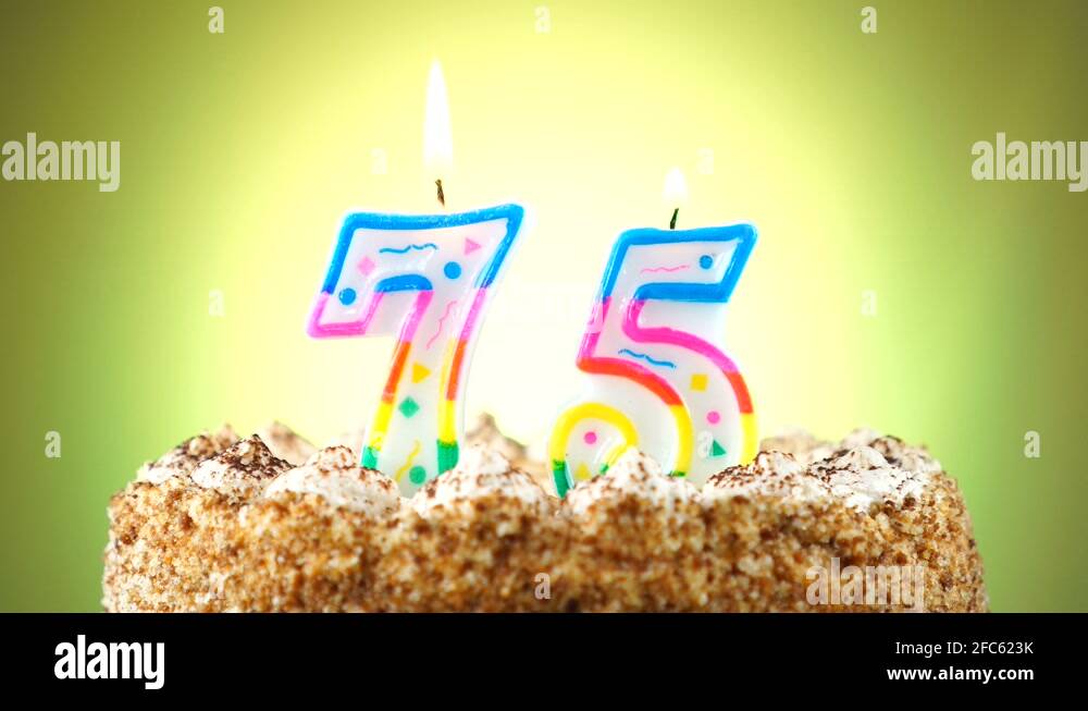 Birthday cake with a burning birthday candle. Number 75. Background ...