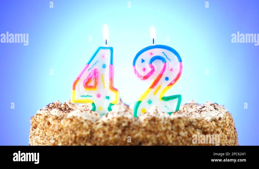 Birthday cake with a burning birthday candle. Number 42. Background ...