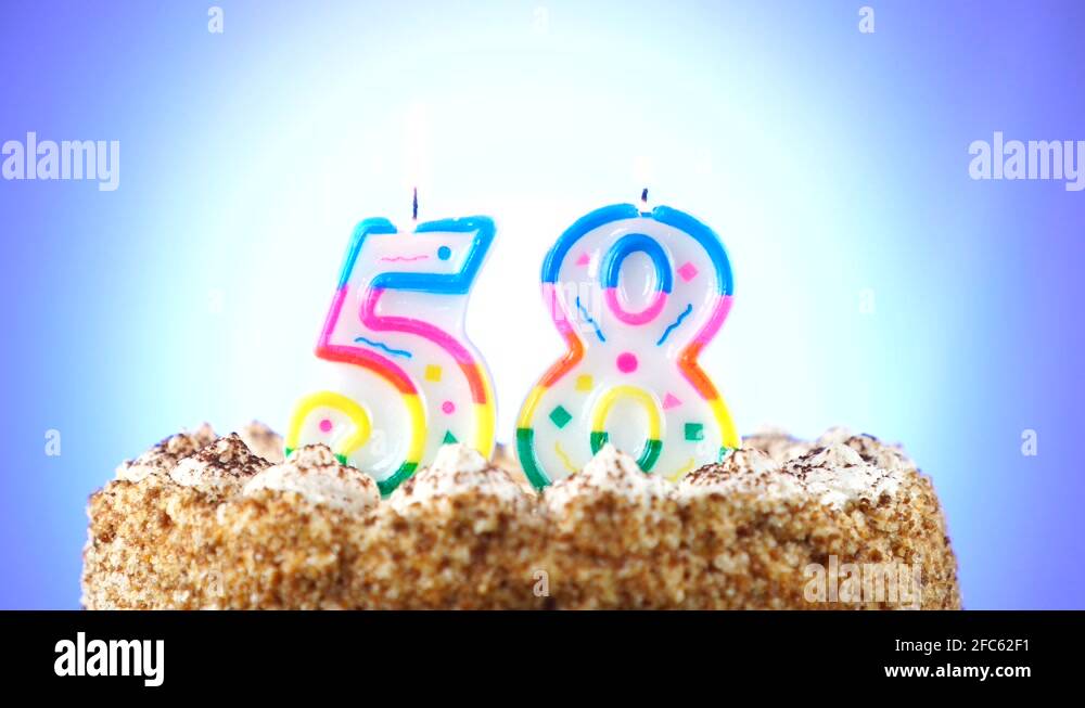 Birthday cake with a burning birthday candle. Number 58. Background ...