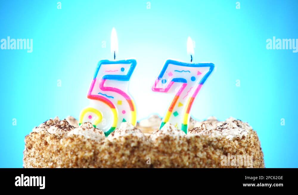 Birthday cake with a burning birthday candle. Number 57. Background ...