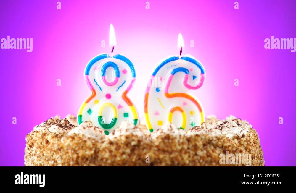Birthday cake with a burning birthday candle. Number 86. Background ...