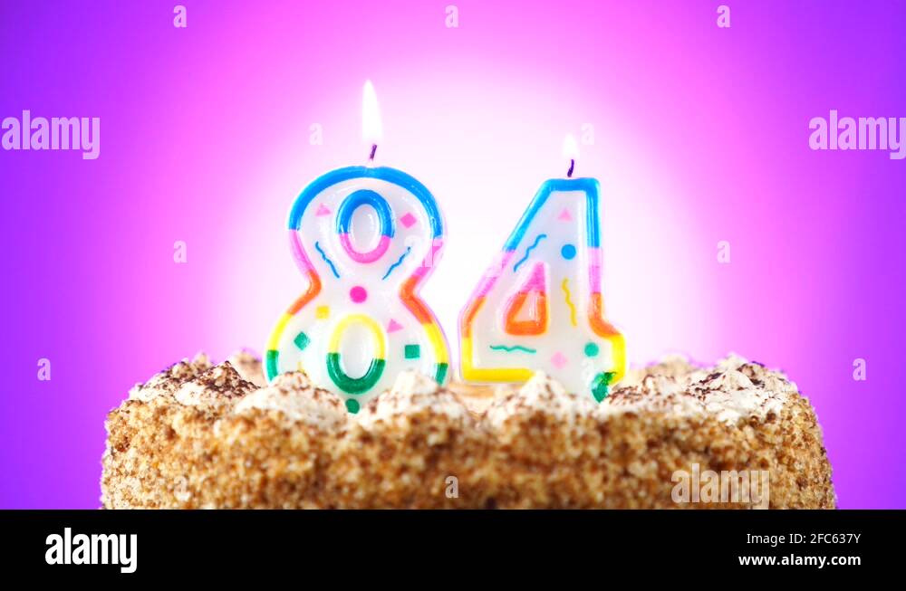 Birthday cake with a burning birthday candle. Number 84. Background ...