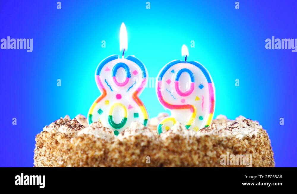 Birthday cake with a burning birthday candle. Number 89. Background ...