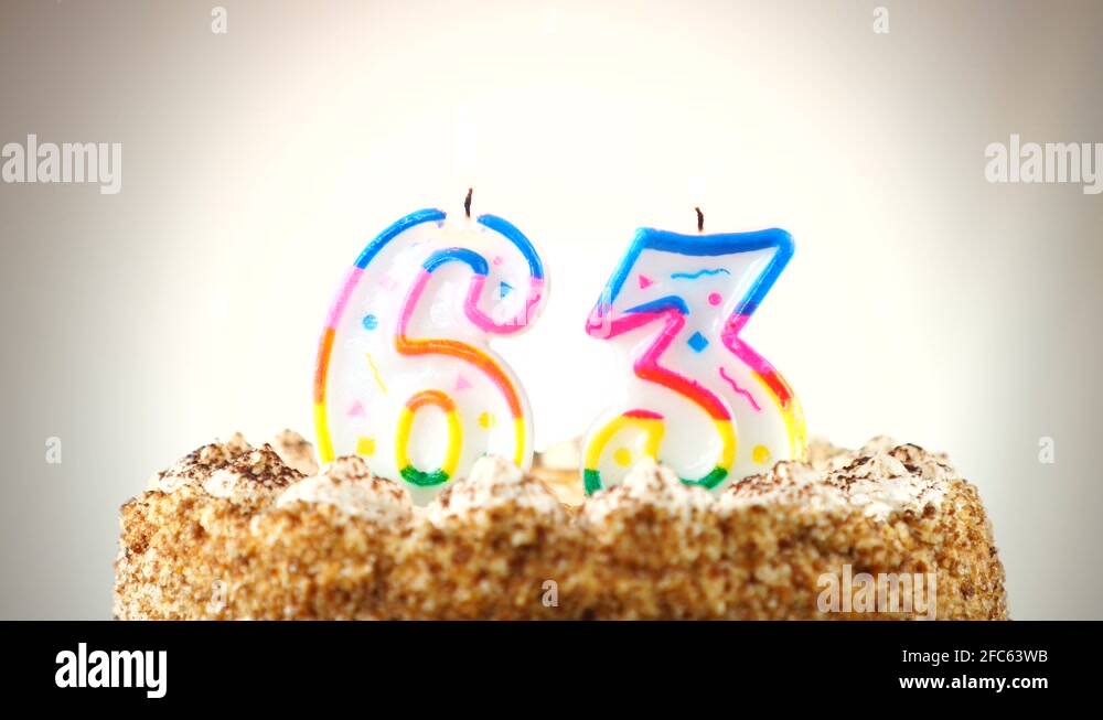 Birthday cake with a burning birthday candle. Number 63. Background ...