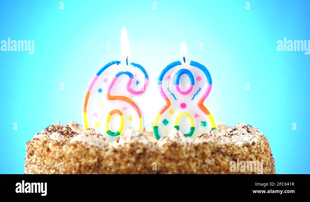Birthday cake with a burning birthday candle. Number 68. Background ...