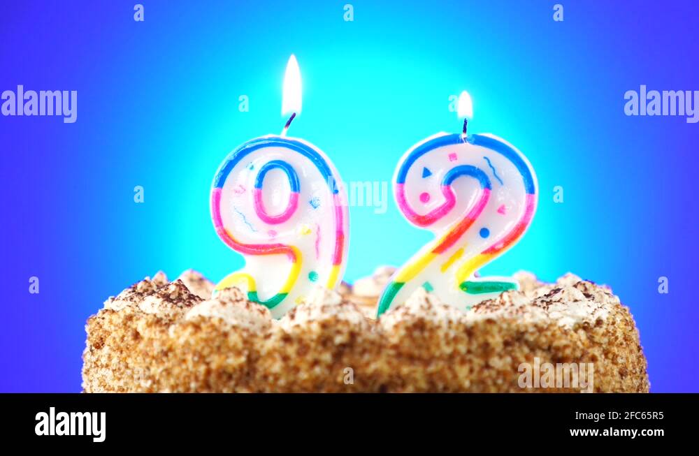 Birthday cake with a burning birthday candle. Number 92. Background ...